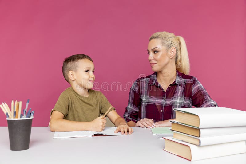 Tutor with Child Doing Homework Together in the Pink Room. Stock Photo ...