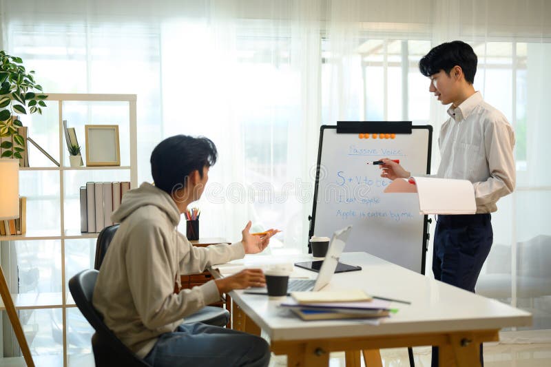 Tutor Explaining Grammar Rules on a Whiteboard while Student Listens ...