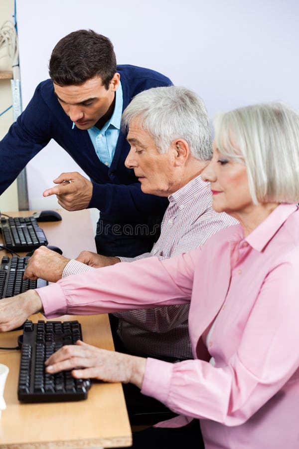 Teacher Explaining Senior Men Computer Class Stock Photos - Free ...