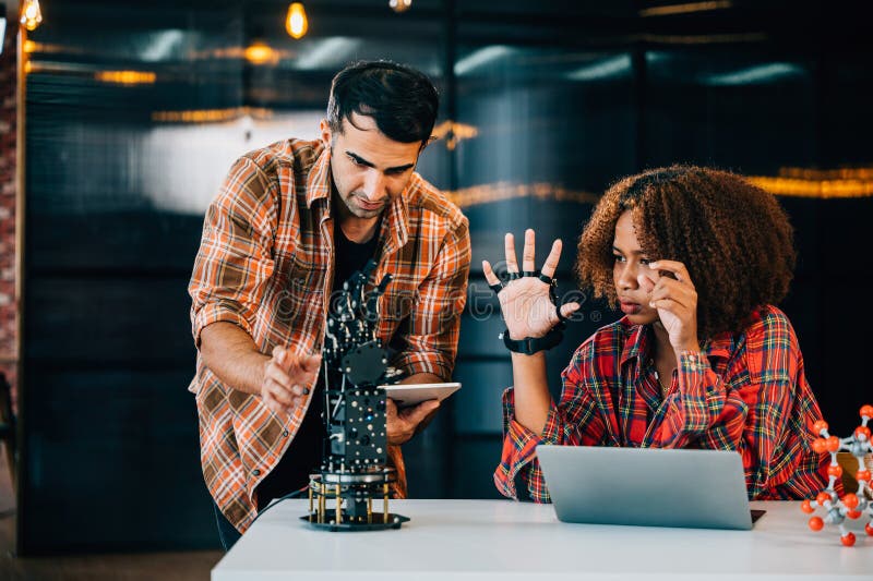 A Tutor Guides a Student in Constructing a Robotic Arm for Design and ...