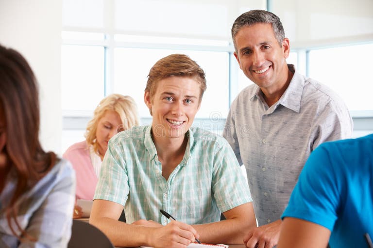 Tutor Helping Student in Class Stock Image - Image of casual, learning ...