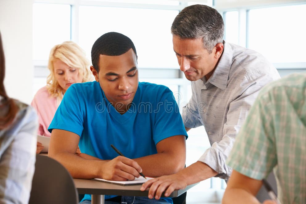 Tutor Helping Student in Class Stock Image - Image of portrait, group ...