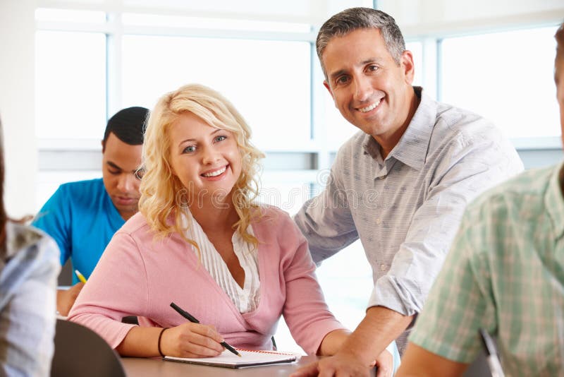 Tutor Helping Student during Class Stock Photo - Image of academic ...