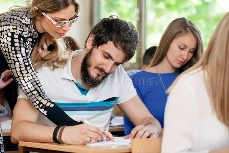 Tutor Helping Student in Class Stock Image - Image of education ...