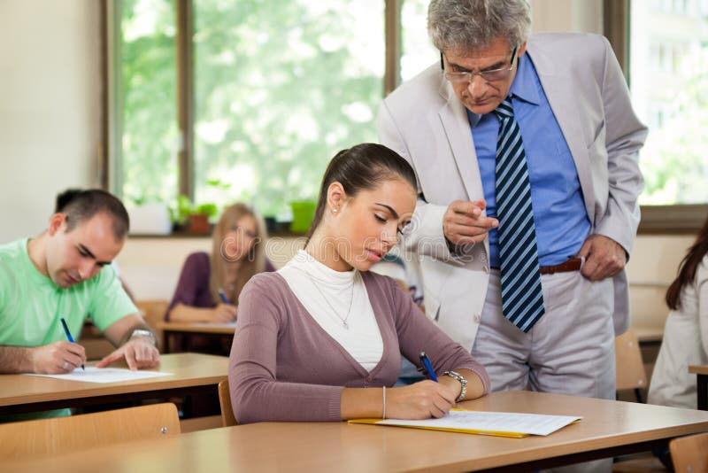 Tutor Helping Student in Class Stock Image - Image of classroom ...