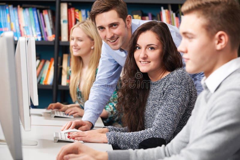 Tutor Helping Students Working at Computer Stock Image - Image of girl ...