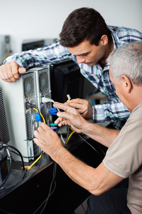 Tutor and Senior Student Fixing Computer in Class Stock Photo - Image ...