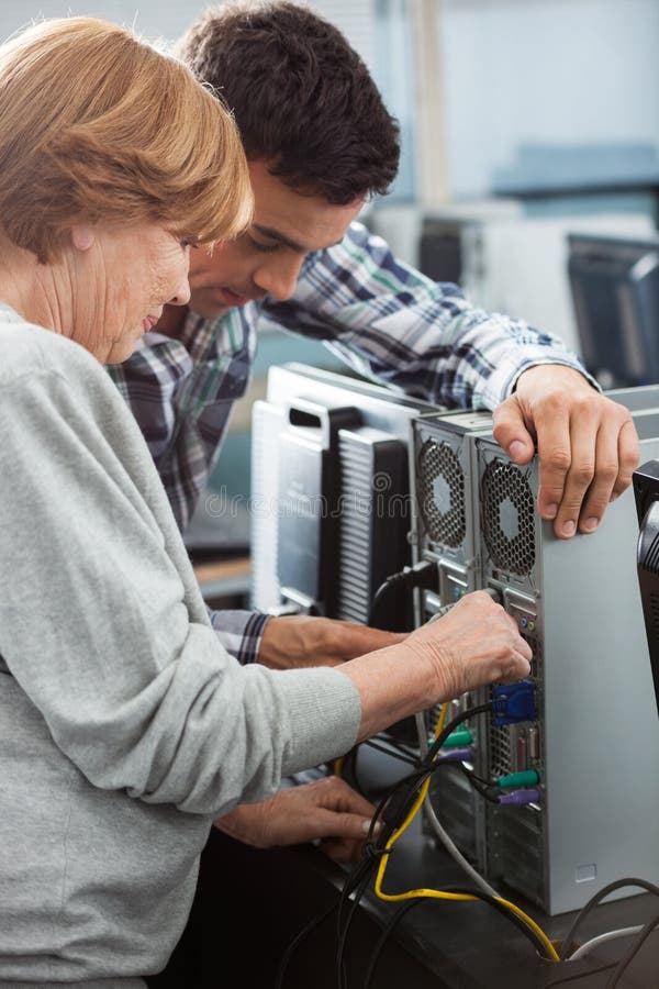 Tutor and Senior Student Fixing Computer in Class Stock Photo - Image ...