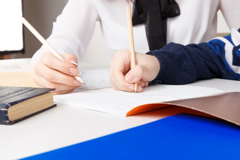 Tutor and Student Sitting in the White Room and Doing Tasks for Lessons ...
