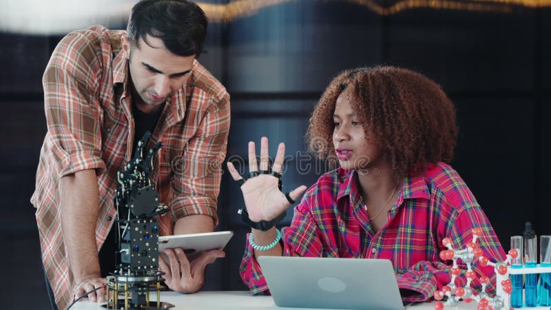 A Tutor Supports a Student in Building a Robotic Arm for Design and ...