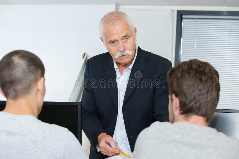 Tutor Teaching Class while Two Students Listening Stock Photo - Image ...