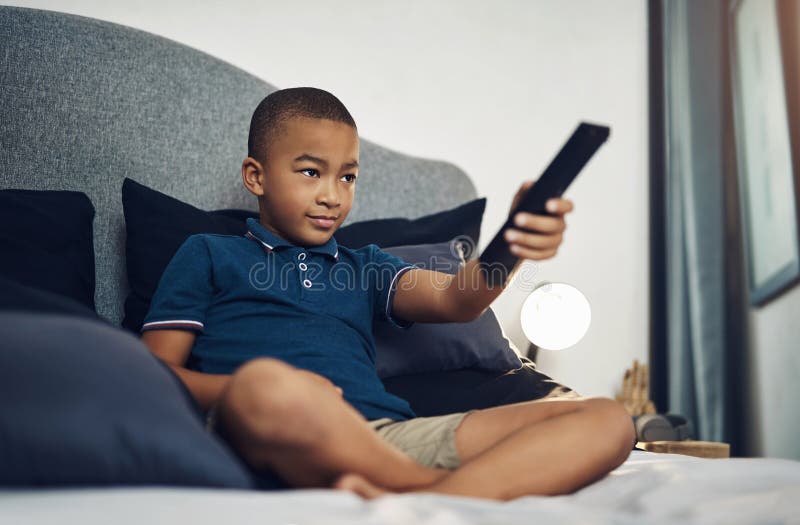 Tv Can Be a Helpful Tool in Learning. a Young Boy Using a Remote ...