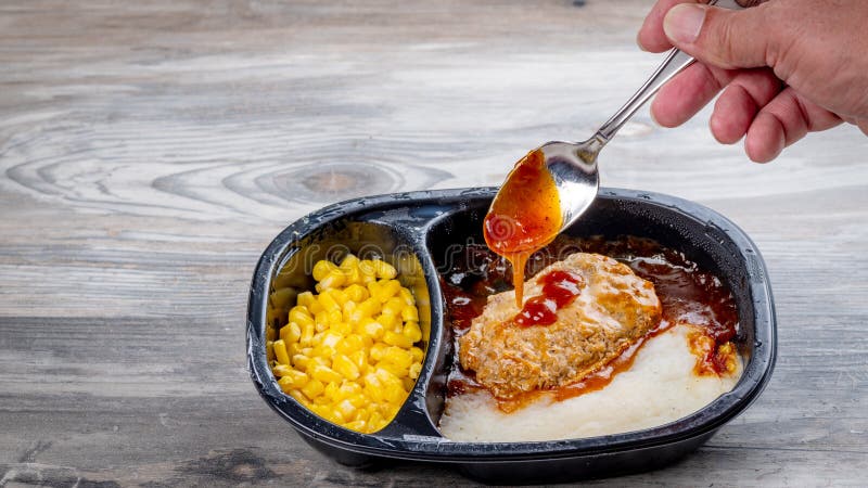 TV Dinner and Spooning Gravy Over the Meat Portion Stock Photo - Image ...