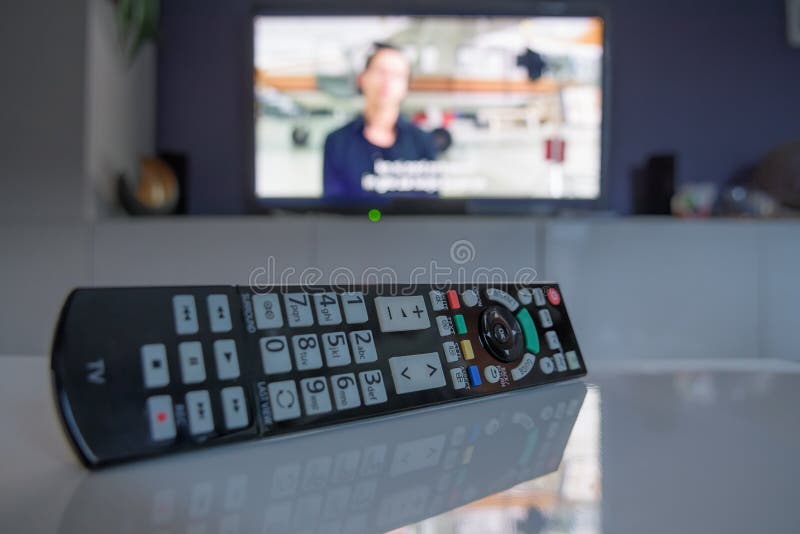 TV Remote Controller on Coffee Table in Front of Smart Television Set ...
