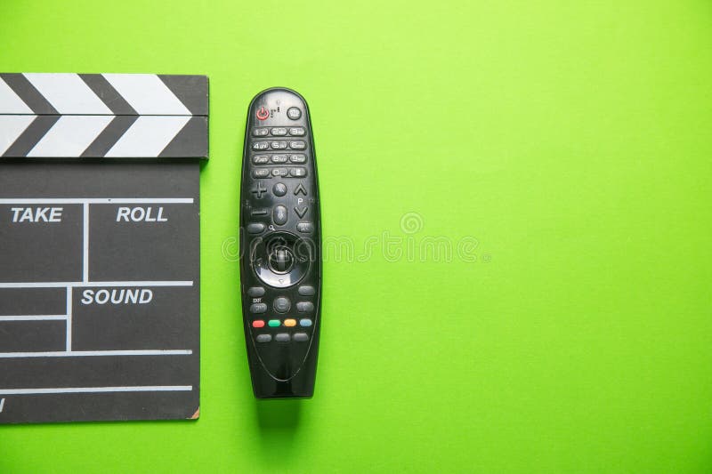 TV Remote Controller and Movie Clapper Board on the Green Background ...