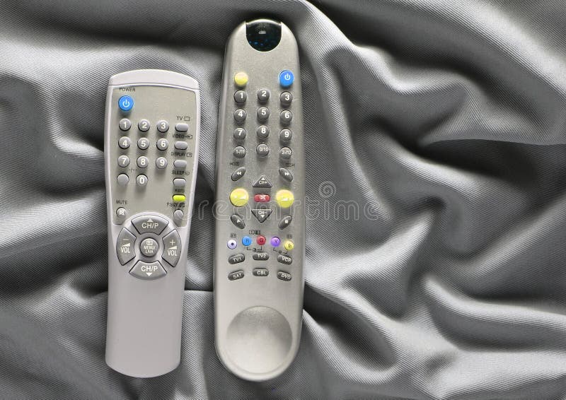TV Remote Controls on a Gray Silk Background. Stock Photo - Image of ...
