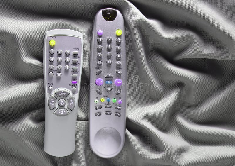 TV Remote Controls on a Gray Silk Background. Stock Photo - Image of ...