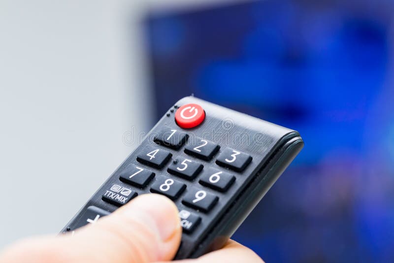 TV remote controls in hand stock photo. Image of television - 166668178