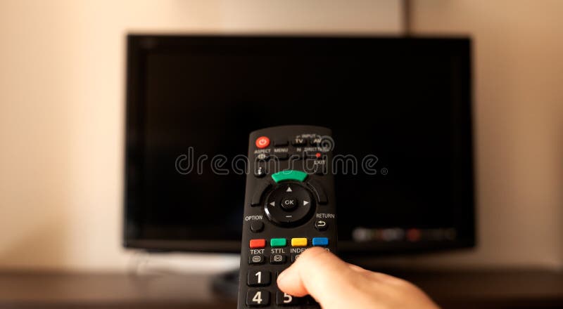 TV Remote in the Foreground with the Finger on the Buttons Stock Image ...