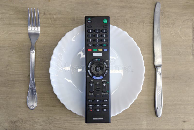TV Remote on a Plate with Cutlery. Concept of Mindless Absorption of ...