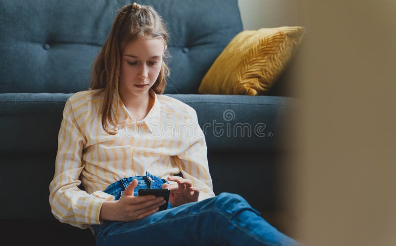 Tween girl with smartphone stock photo. Image of holding - 212503044