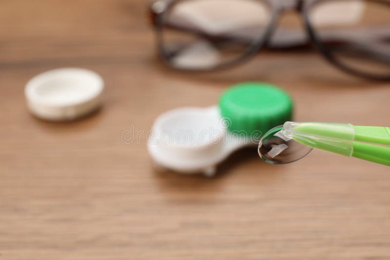 Tweezers with Contact Lens Over Table, Closeup. Space for Text Stock ...