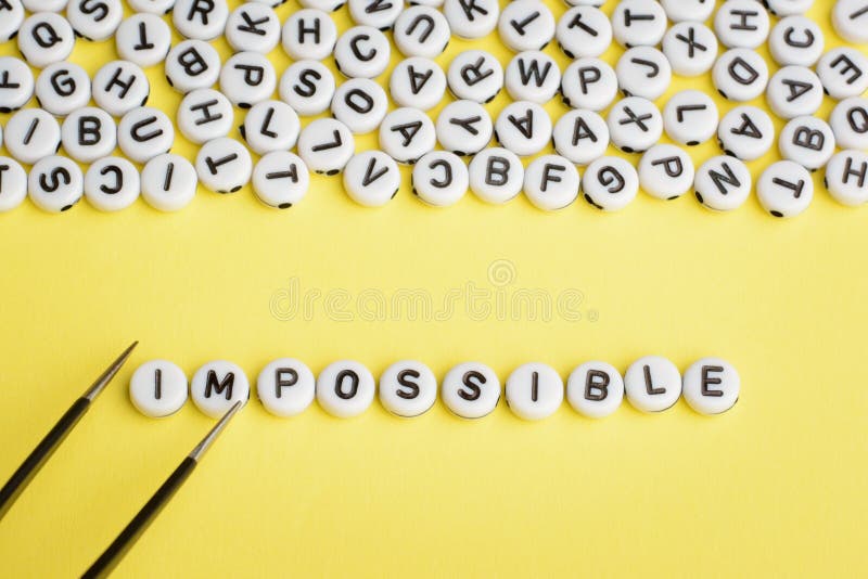 IMPOSSIBLE Word Made by White Plastic Blocks on a Yellow Background ...