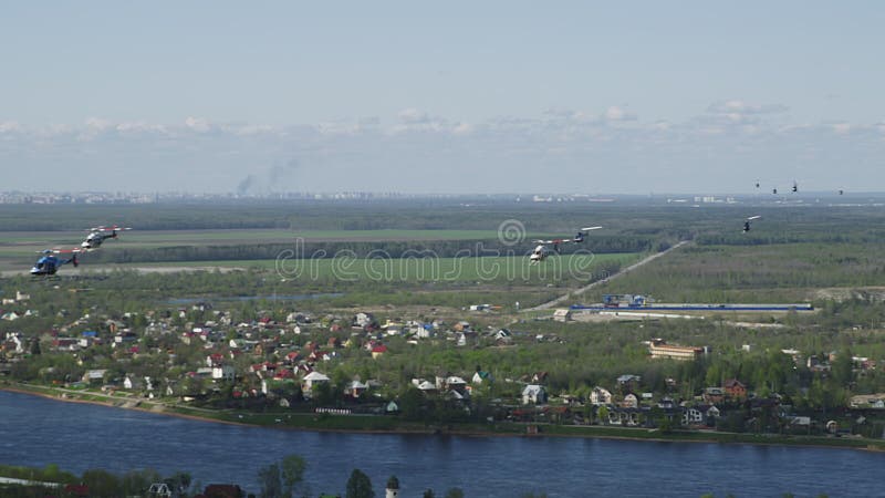Twelve Helicopters Fly One after Another Over a Large River on a Sunny ...