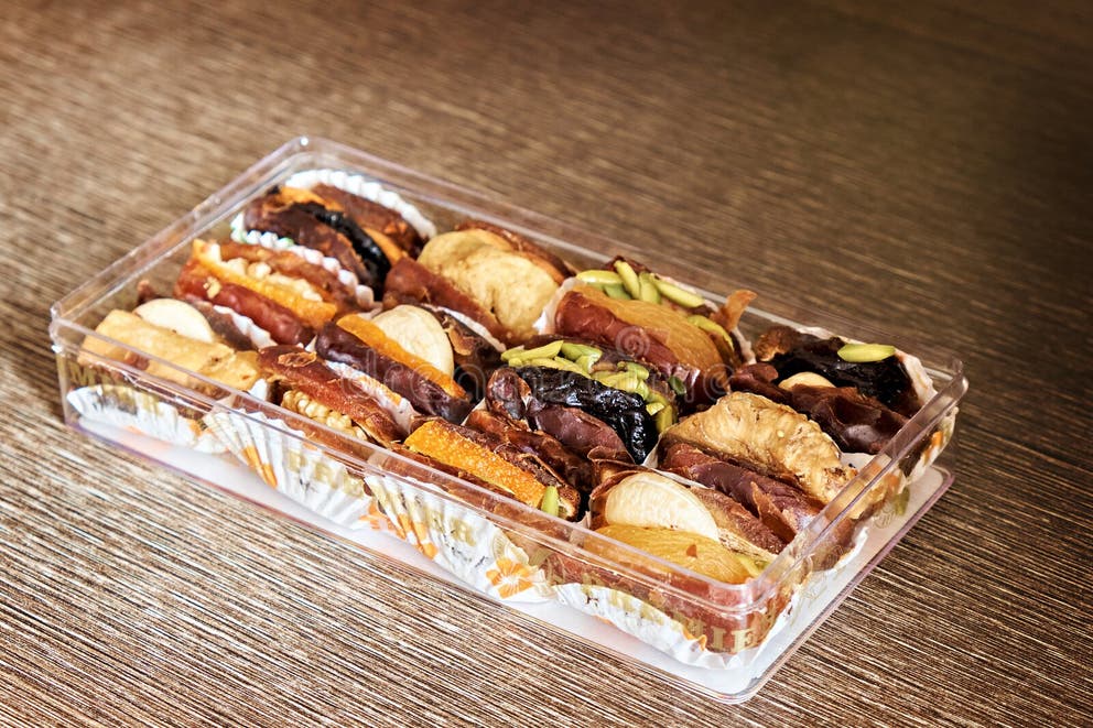 Twelve Stuffed Dates in a Box on a Dark Background. Dates with Nuts, a ...