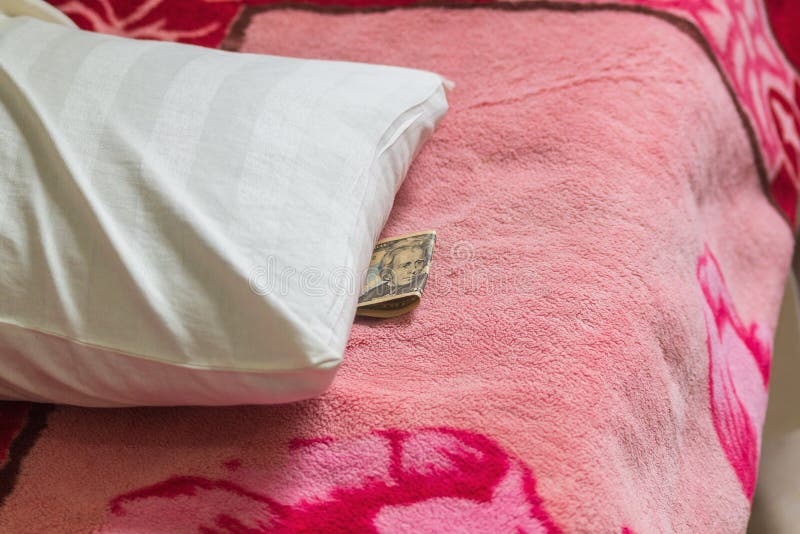 A Twenty-dollar Bill Placed Under a Pillow Above the Bedspread. Form of ...