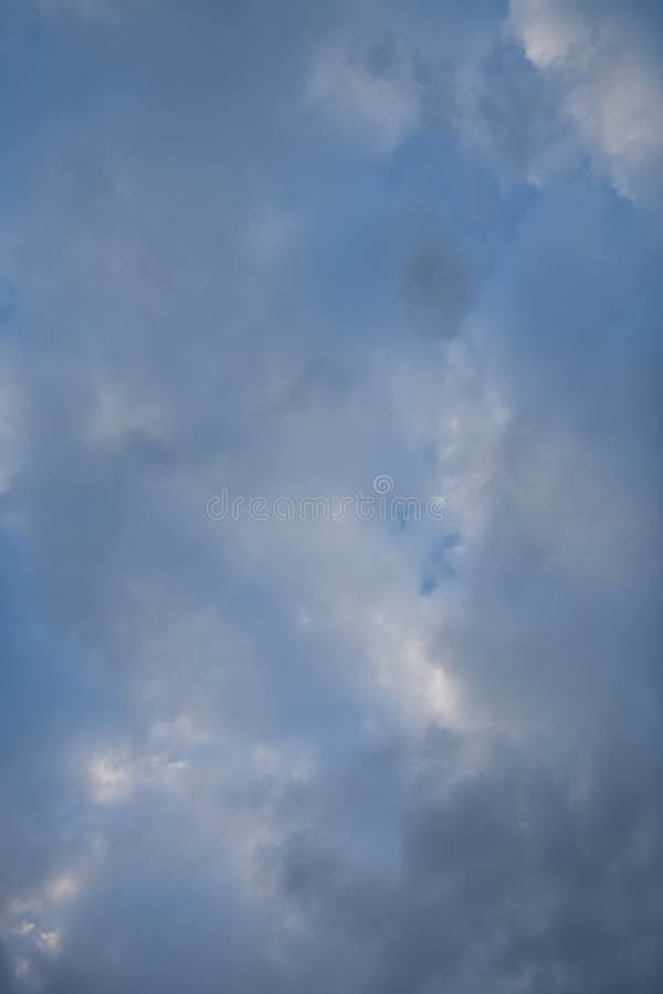 A Blue Sky at Twilight Behind White, Grey and Dark Grey Clouds Stock ...