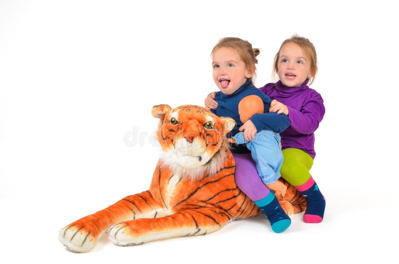 Twin Girls riding a Tiger stock image. Image of children - 38746475