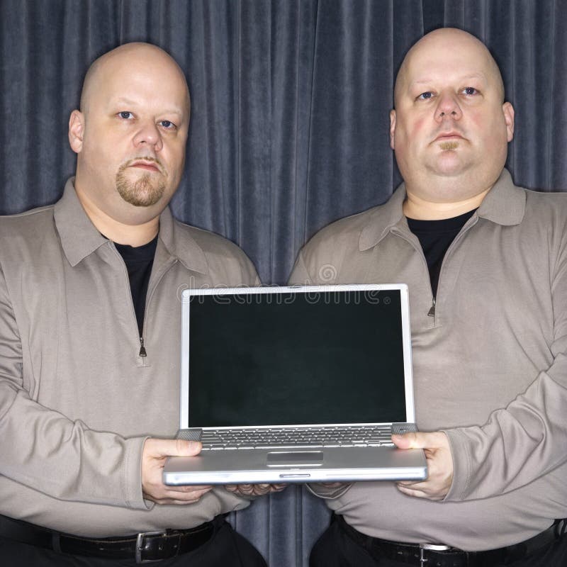 Twin men with laptop stock photo. Image of portrait, male - 2431226