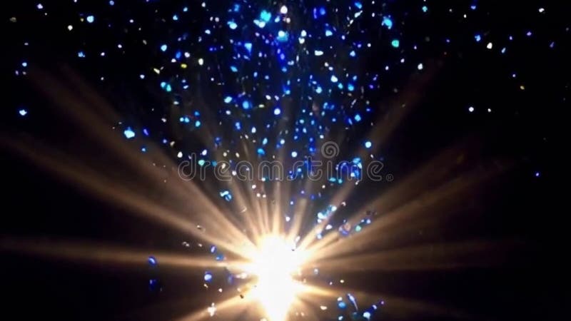 Twinkling Blue Glitter Falling in Glowing Light Rays Stock Footage ...
