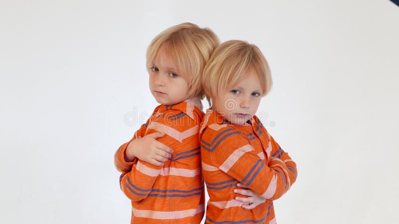 Twins Brothers Standing Back To Back Stock Footage - Video of isolated ...