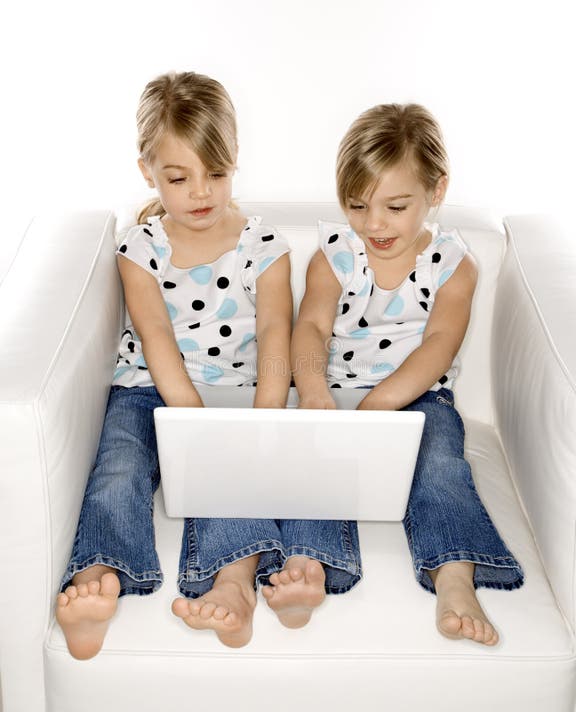 Twins playing on computer. stock image. Image of female - 2045801