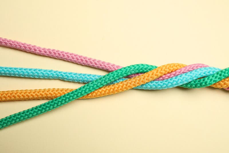 Twisted Colorful Ropes on Beige Background. Unity Concept Stock Image ...