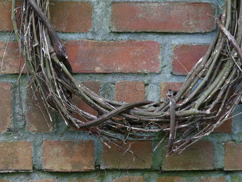 Twisted Grape Vine Wreath Hung on a Red Brick Wall Partial View Stock ...