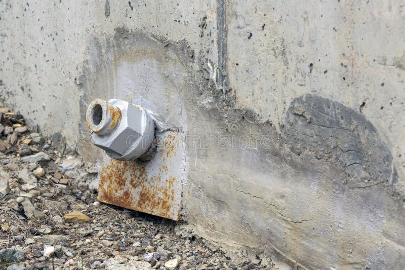 Twisted Metal Nut Covered with Rust on the Concrete Wall of the Bridge ...