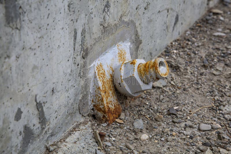 Twisted Metal Nut Covered with Rust on the Concrete Wall of the Bridge ...