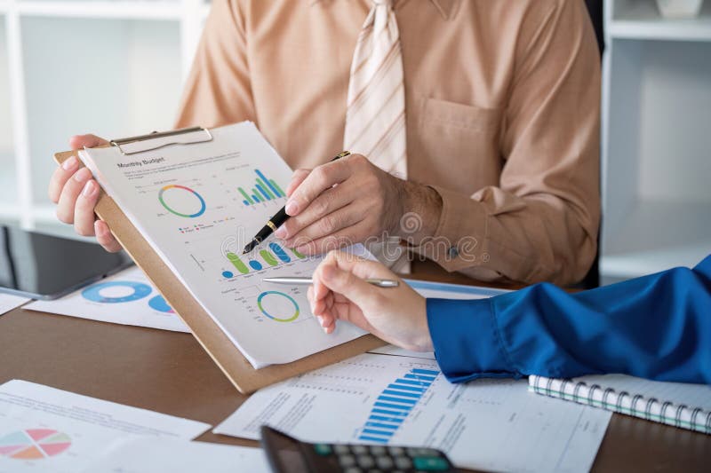 Accountants Reviewing Monthly Budget Metrics and Performance Charts in ...
