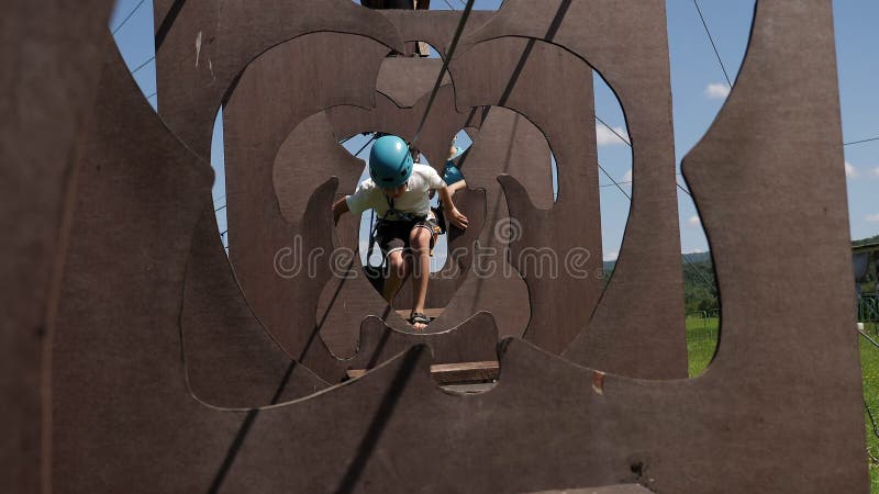 Two Active Brave Boys Pass an Obstacle Course in a Rope Park in the ...