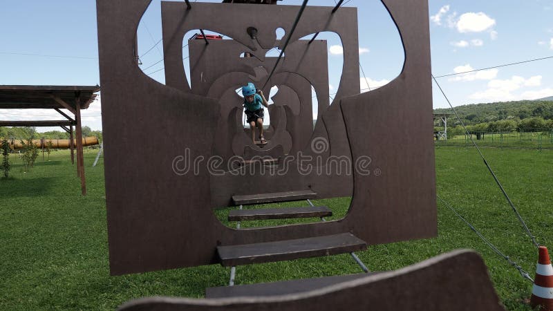 Two Active Brave Boys Pass an Obstacle Course in a Rope Park in the ...