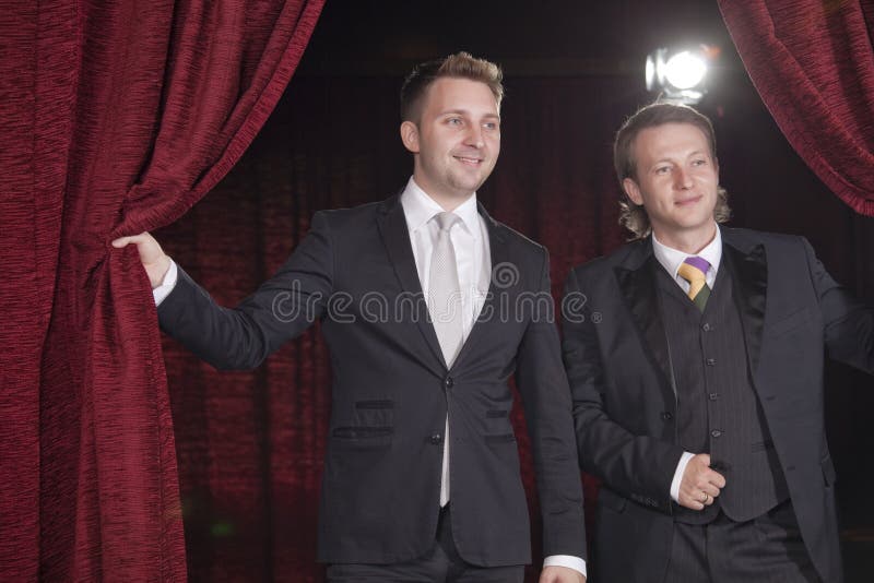 Two actors in spotlight stock photo. Image of male, holding - 15679734