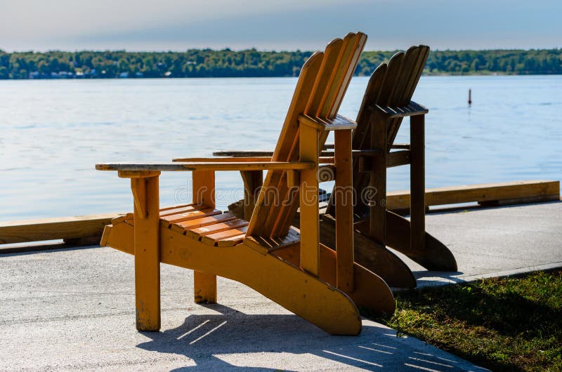 Side View of Two Adirondack Chairs Facing Left at Water S Edge Stock ...