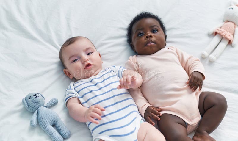 Two Adorable Babies Lying on Bed at Bedroom Stock Photo - Image of ...