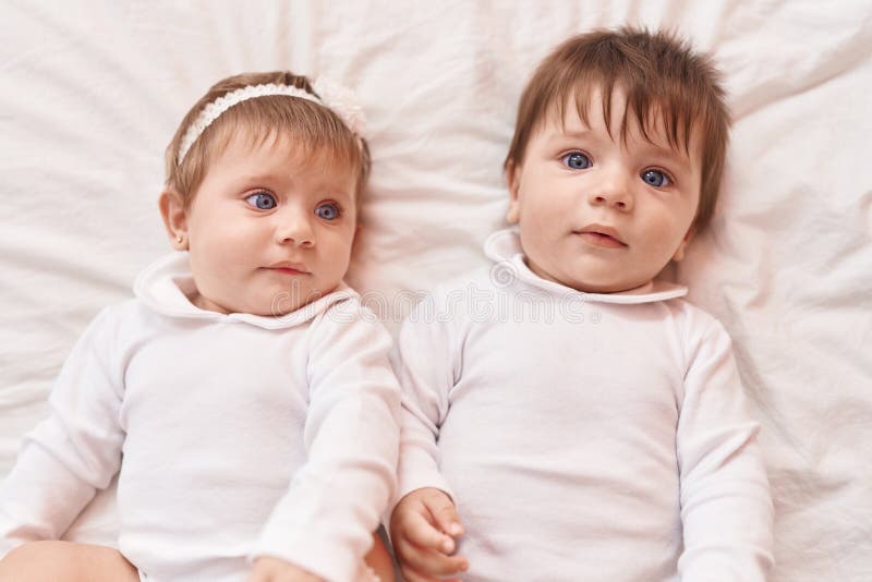 Two Adorable Babies Lying on Bed at Bedroom Stock Photo - Image of ...