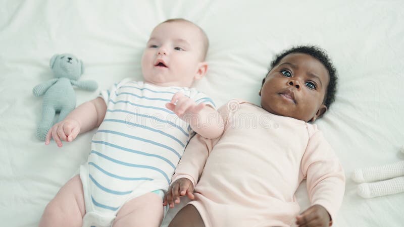 Two Adorable Babies Lying on Bed at Bedroom Stock Photo - Image of ...
