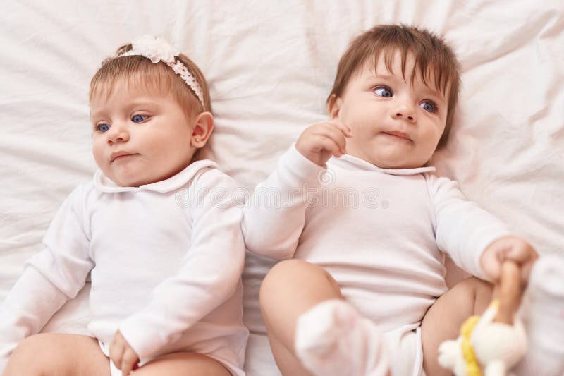 Two Adorable Babies Lying on Bed at Bedroom Stock Image - Image of ...