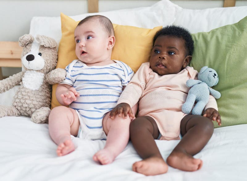 Two Adorable Babies Sitting on Bed at Bedroom Stock Photo - Image of ...